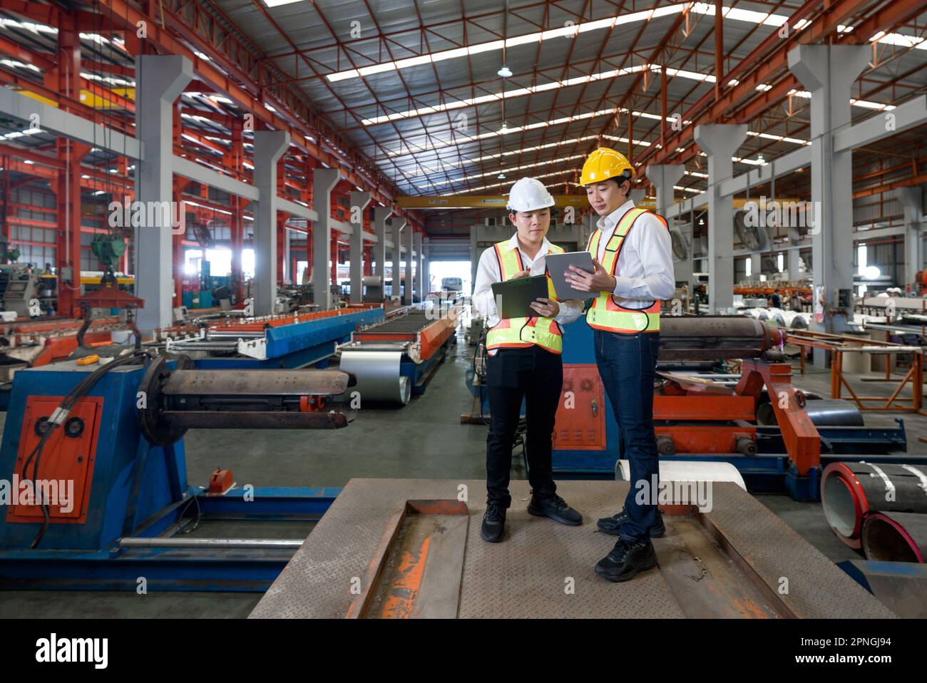 Young asian engineer manager trains new employees within the metal ...