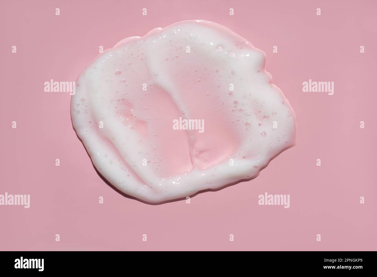 White lather foam moisturizer cream lotion cleanser on pink background ...