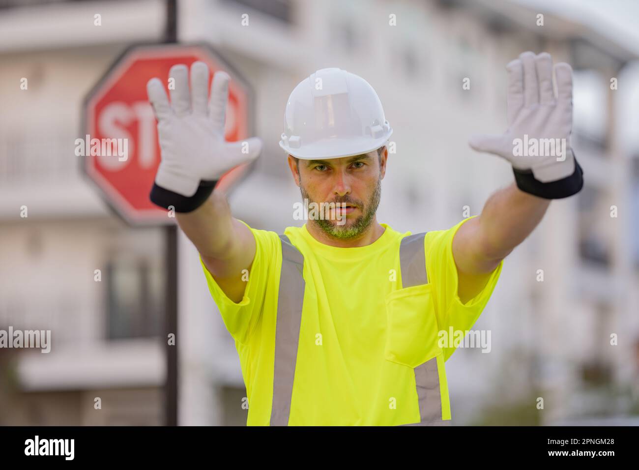 Worker with stop road sign. Builder with stop gesture, no hand ...