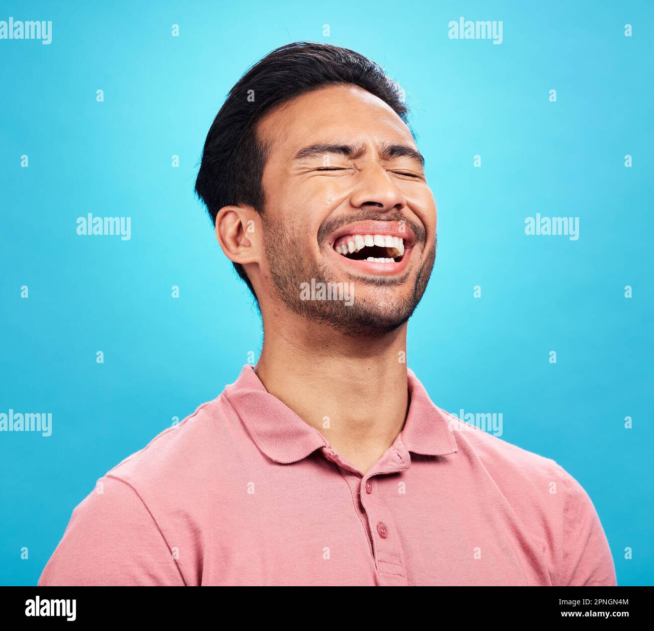 Laughing, funny comedy and man in studio isolated on a blue background ...