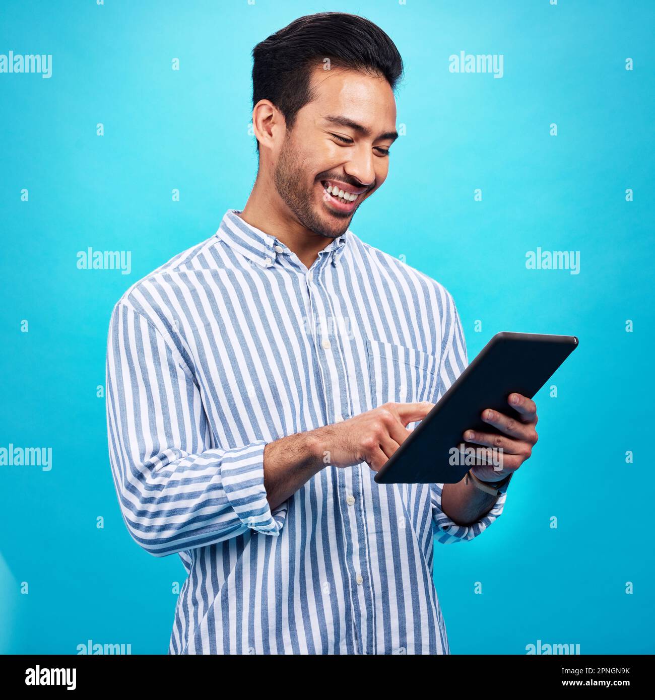 Tablet, man and smile in a studio on social media, internet and website ...