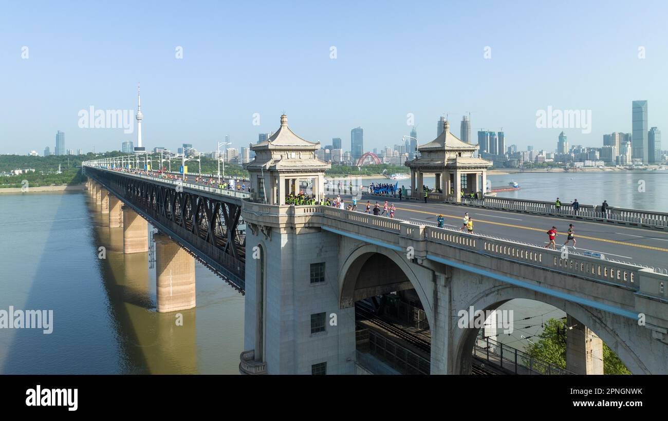 Aerial photo shows runners passing the Wuhan Yangtze River Bridge ...