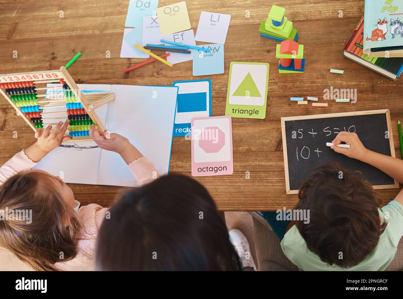 Learning, education and study with family at table from above for ...