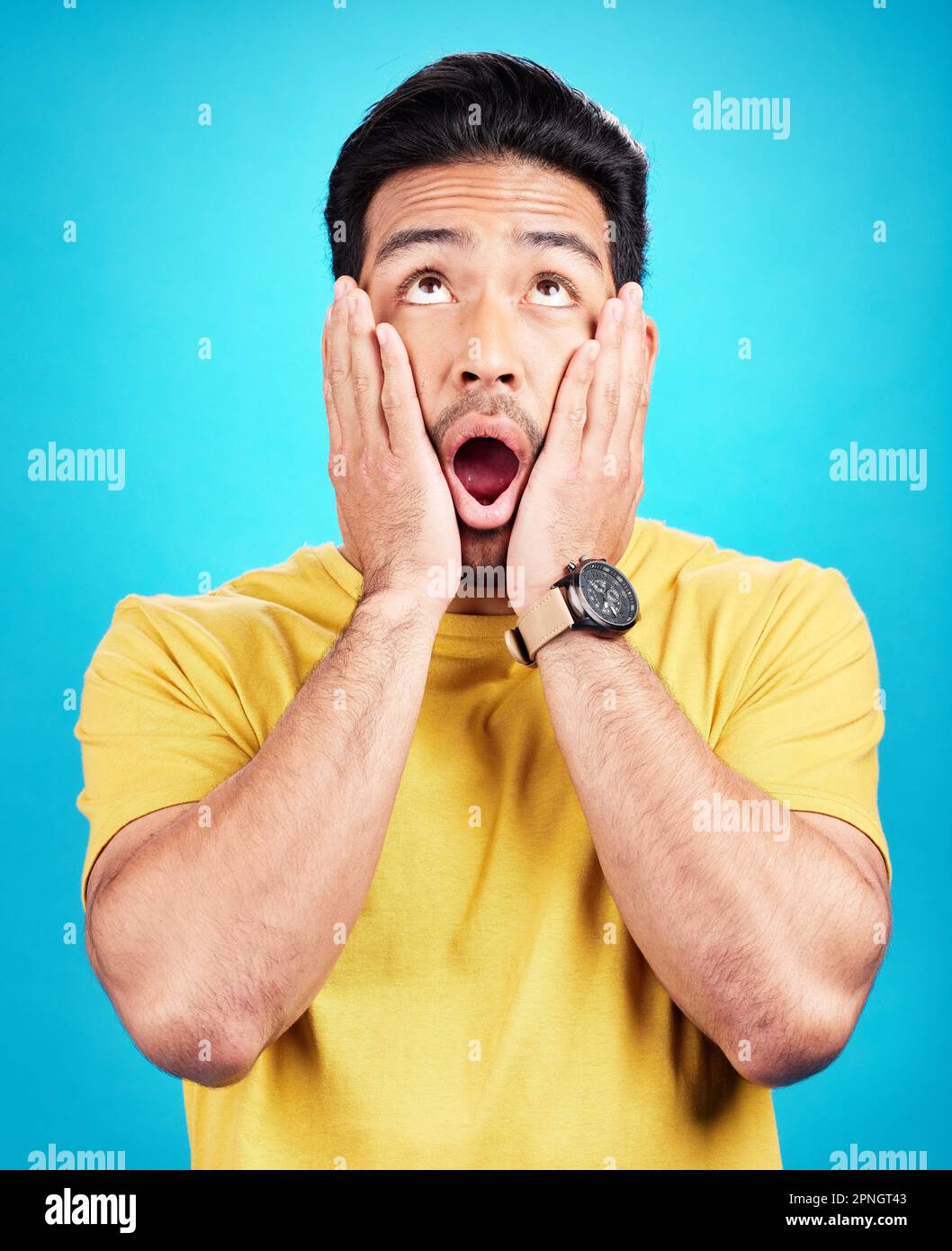 Man, wow and shocked at surprise or announcement in studio with hands ...