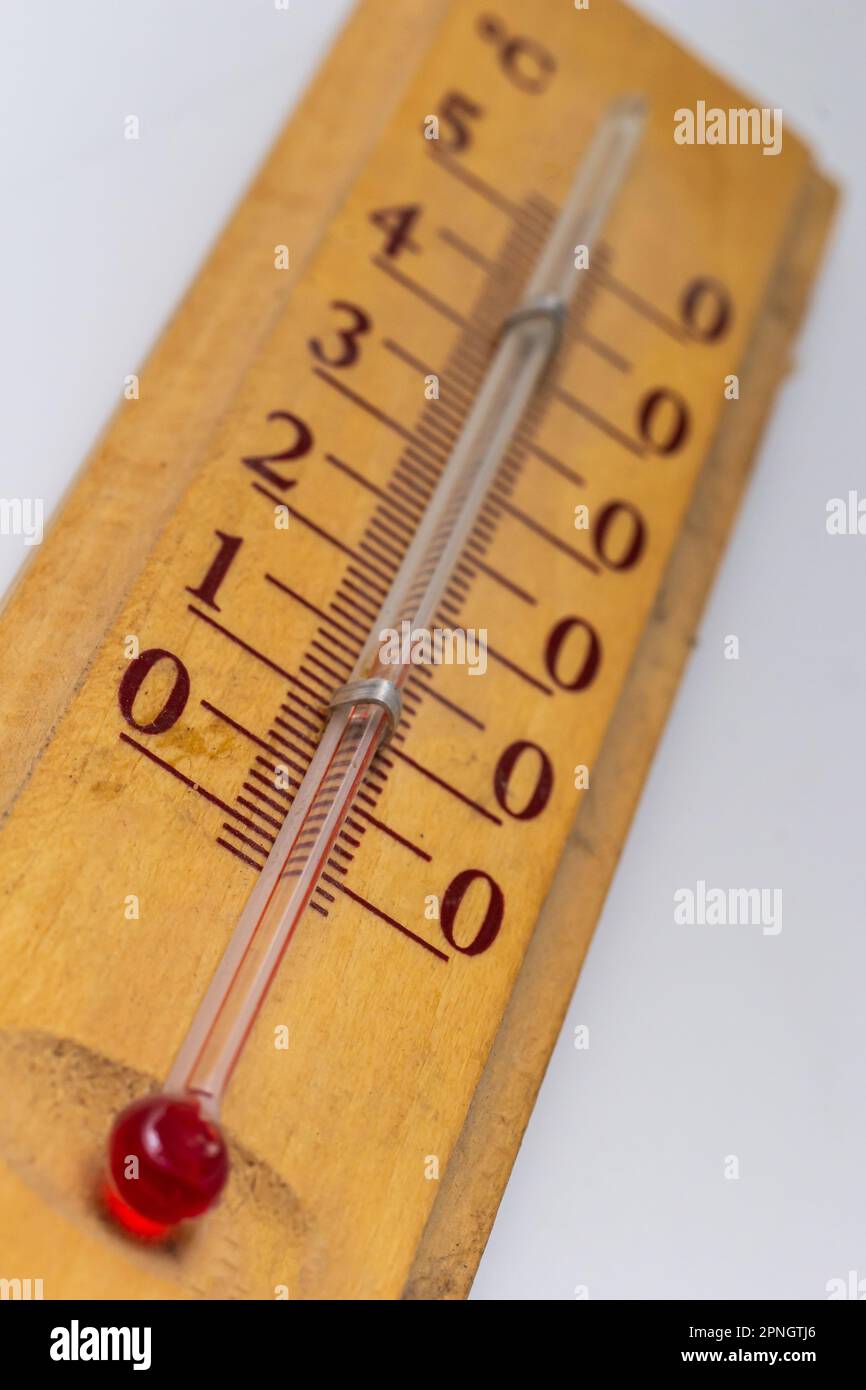 room thermometer on a wooden base close up on a white background ...