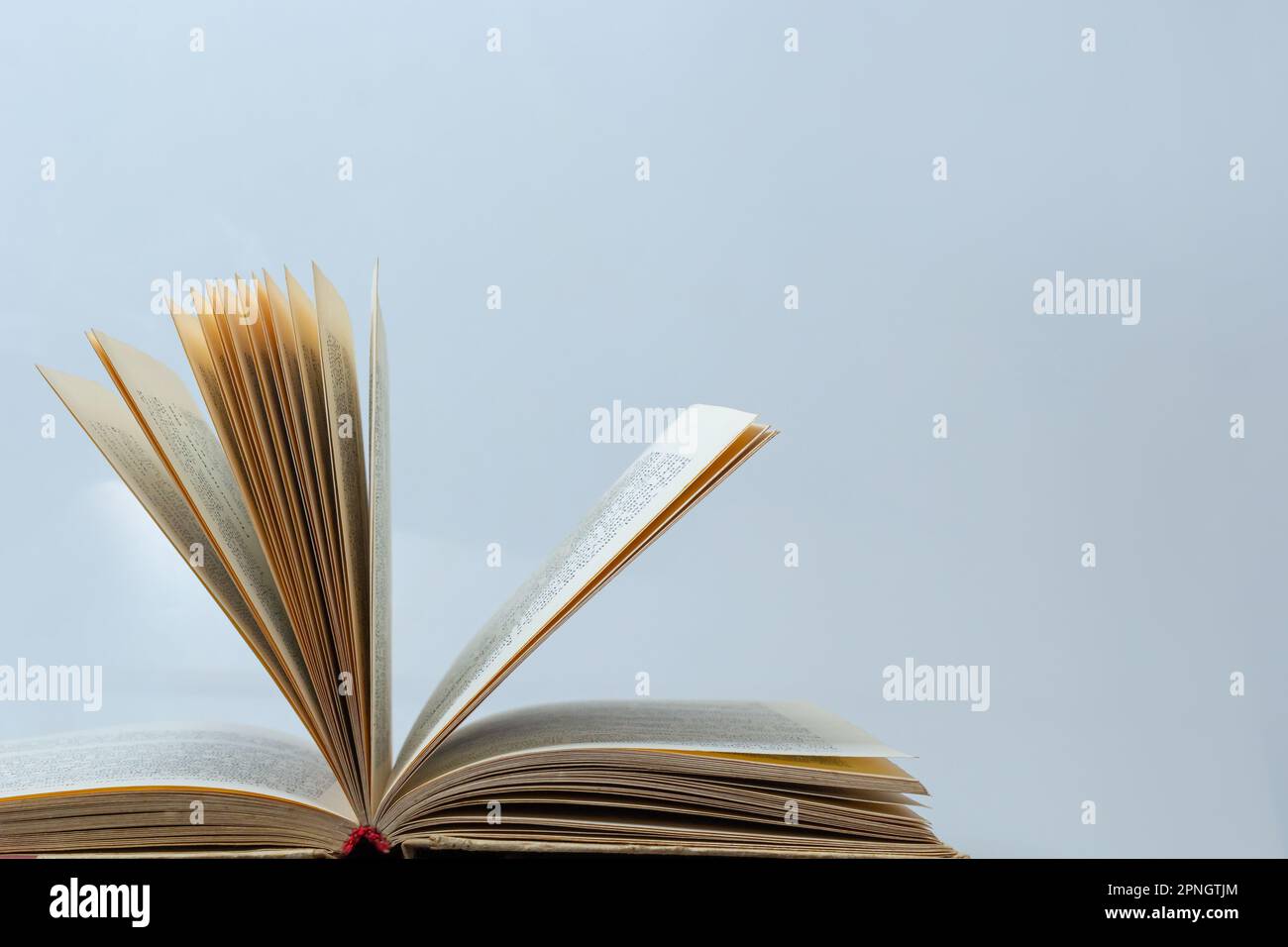 Open old book with text on white background. The concept of reading ...