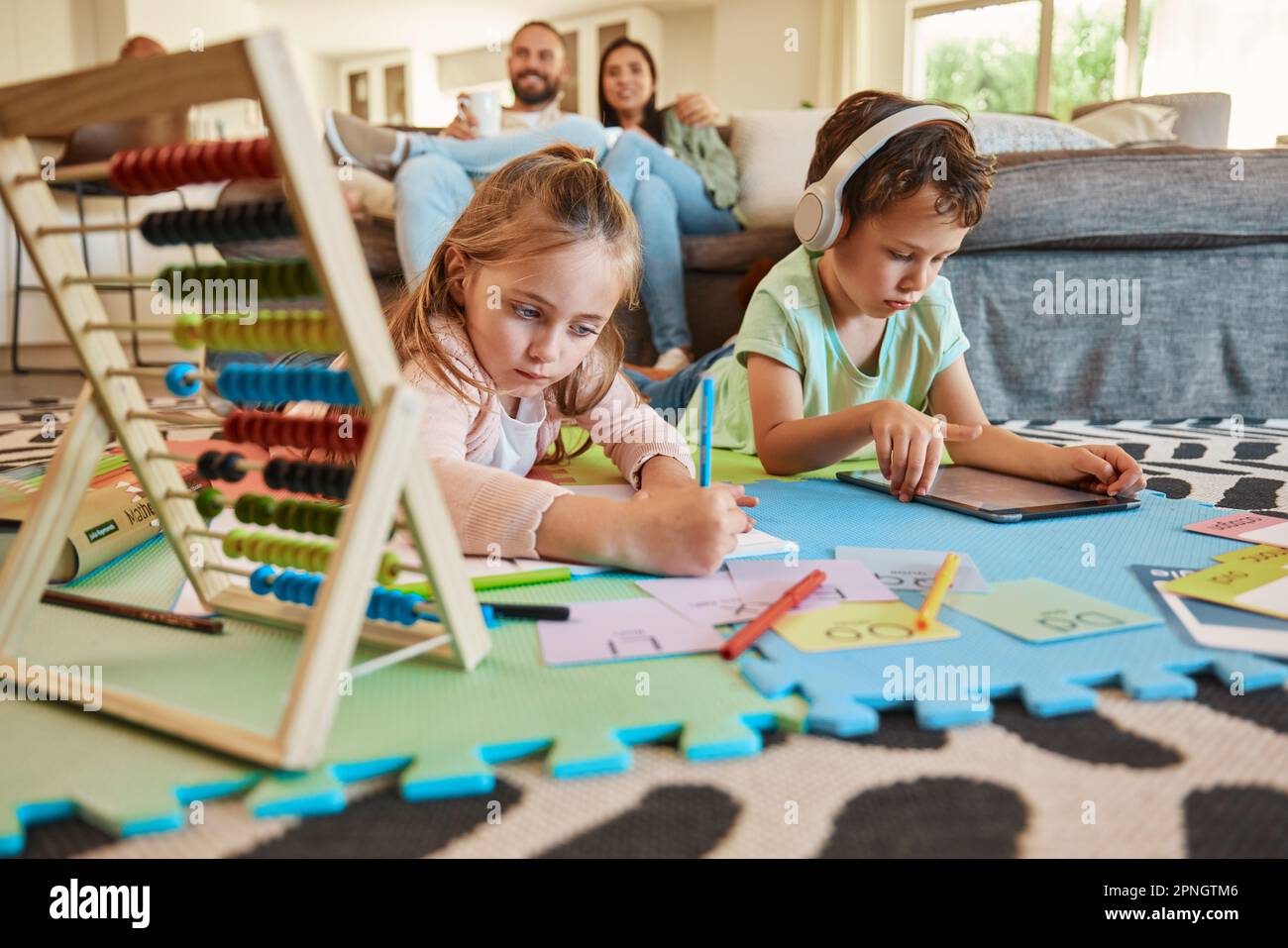 Floor, learning and children with parents relax on sofa for education ...