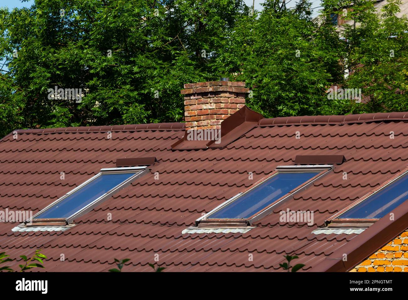 Roof of a new home. Ceramic chimney, metal roof tiles, gutters, roof ...