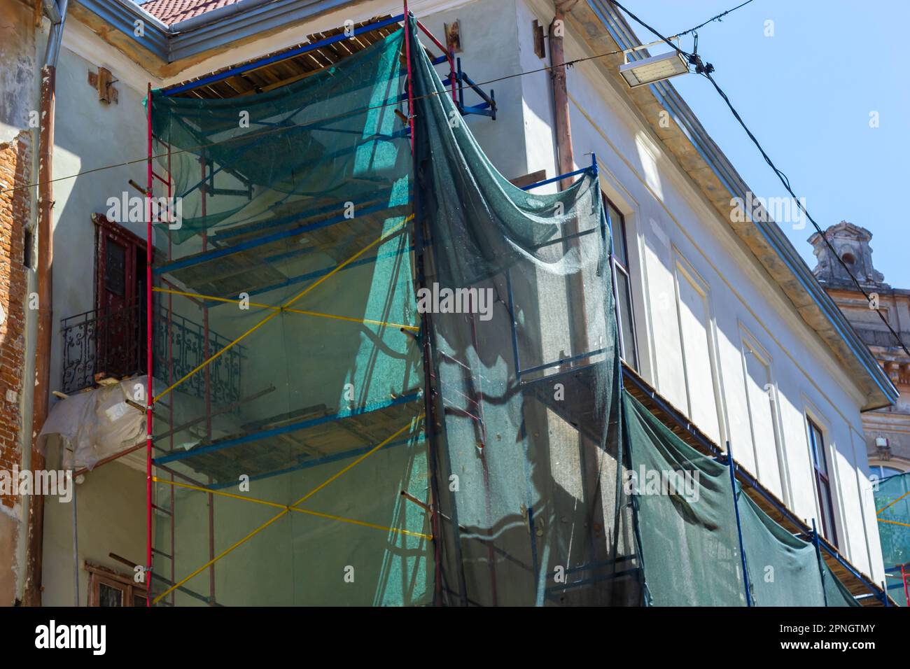 Restoration of the building. Scaffolding and protective green building ...