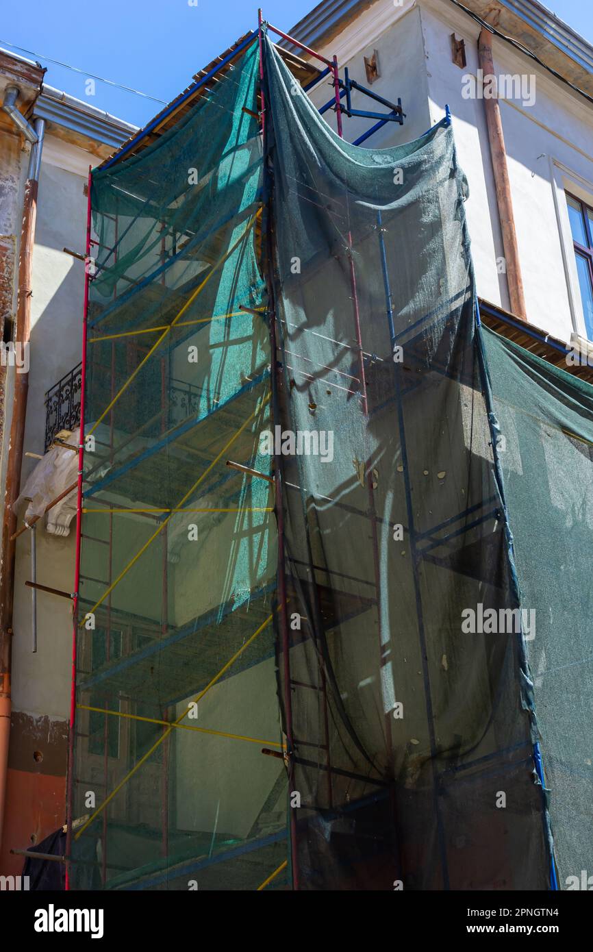 Restoration of the building. Scaffolding and protective green building ...