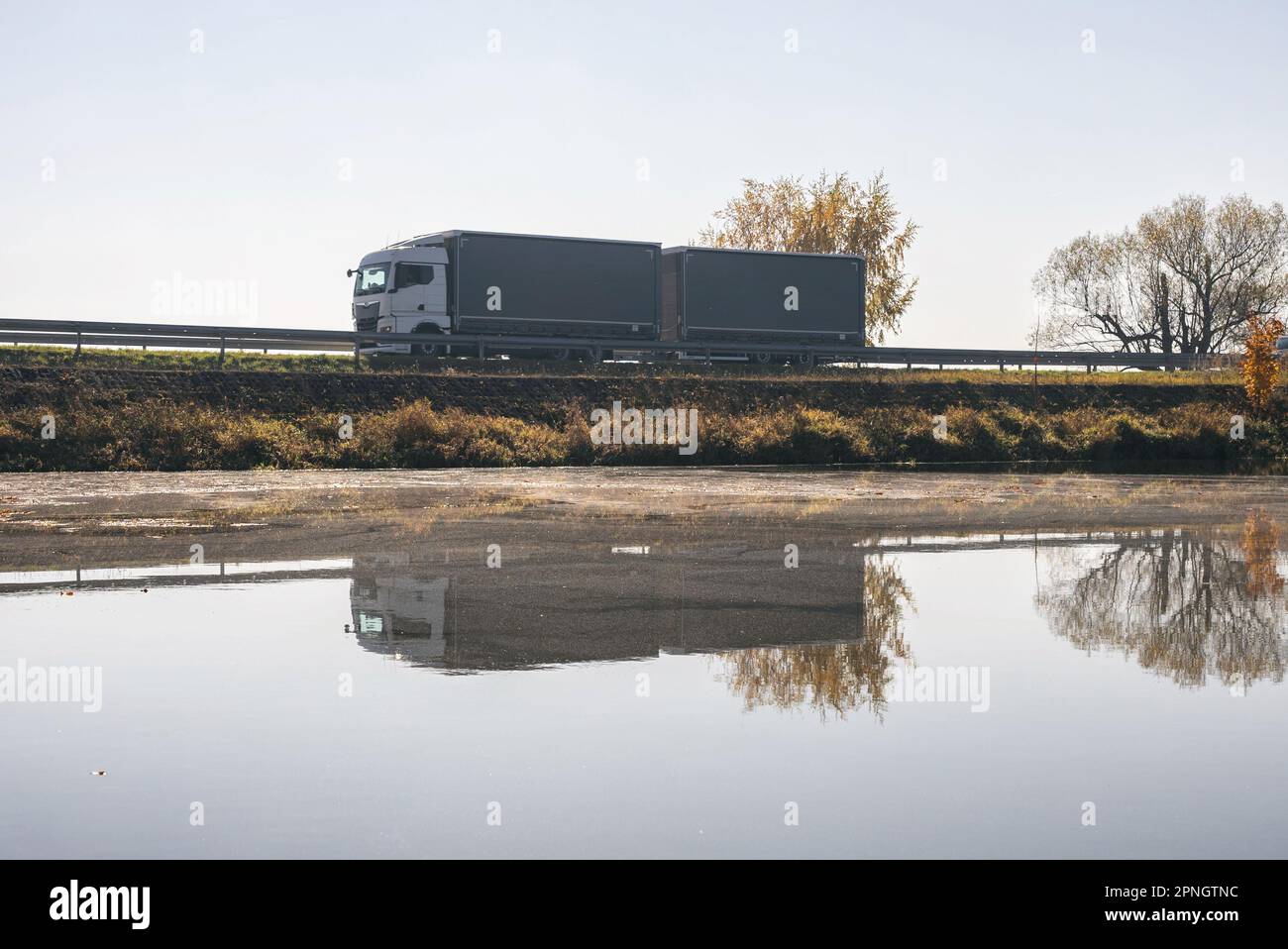 Truck goes on the road in autumn. car transport . Truck with semi ...