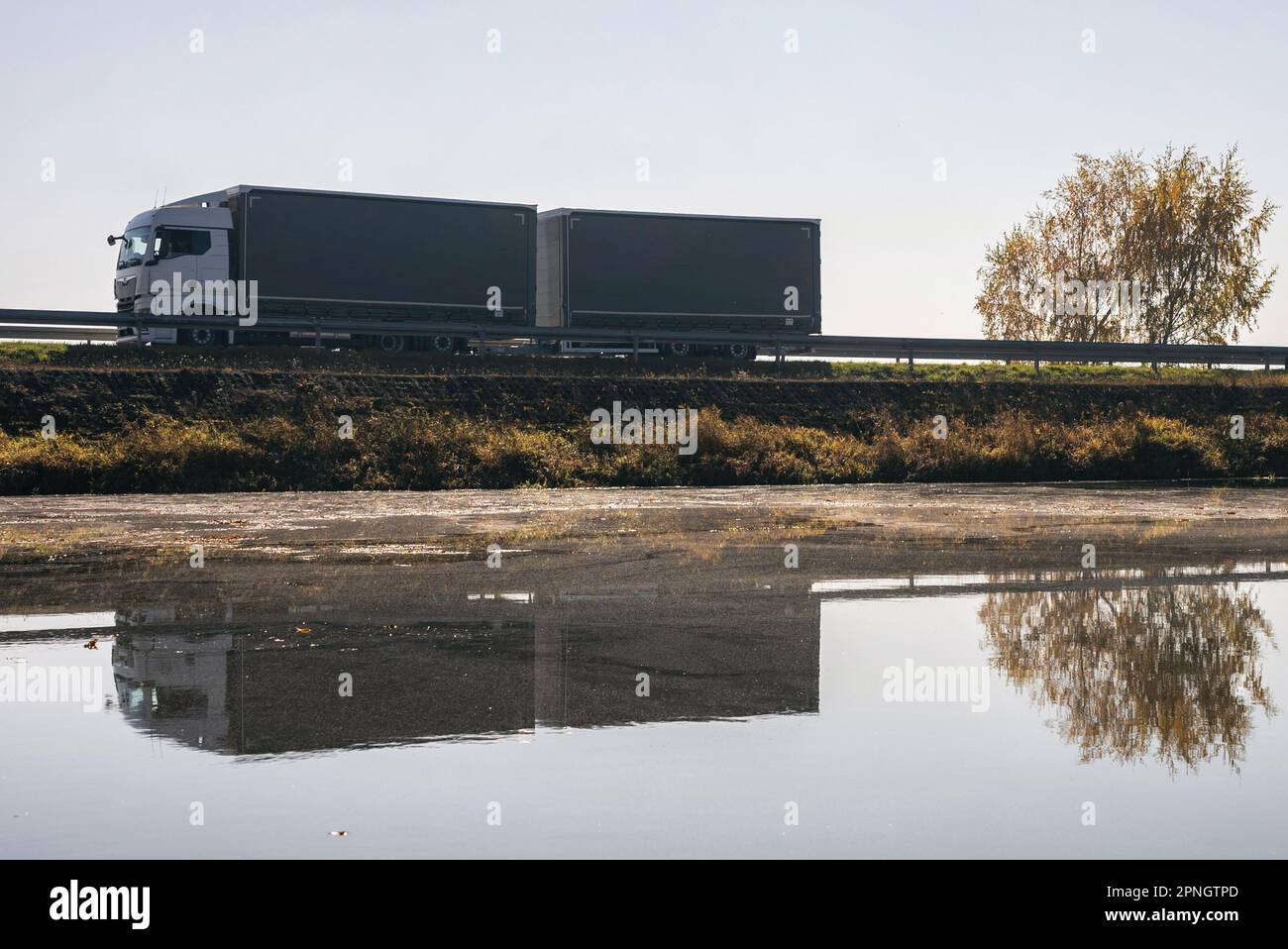 Truck goes on the road in autumn. car transport . Truck with semi ...
