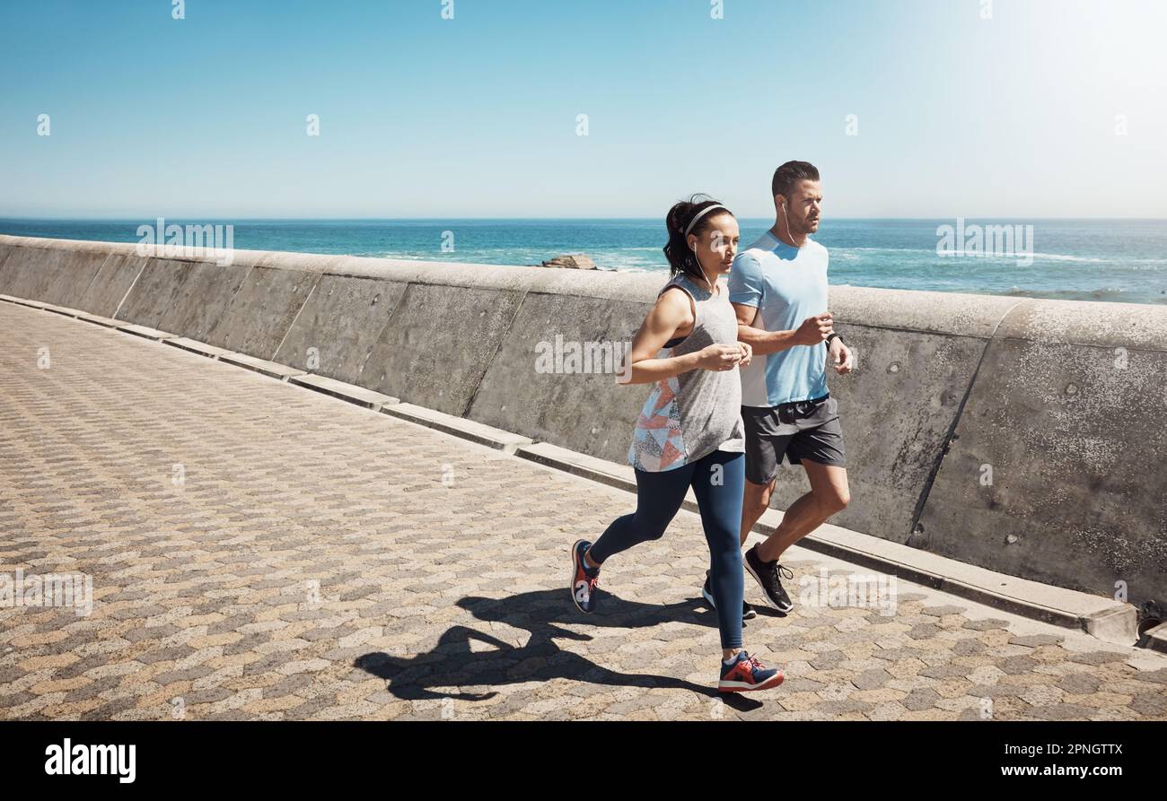 Stretching their limits. Full length shot of a young couple out for a ...