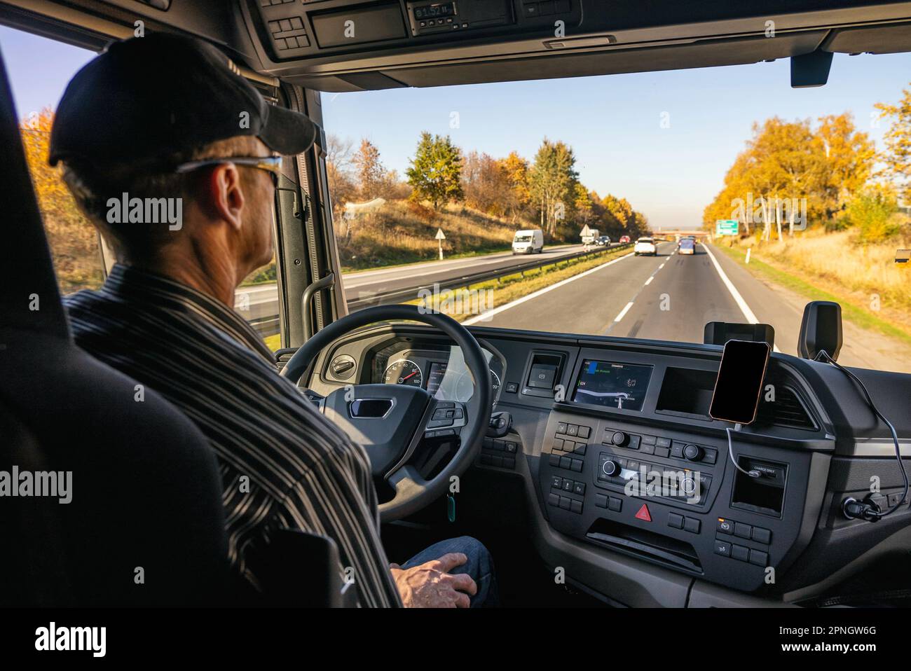 View from inside the cab of the truck. Car transport. The truck is ...