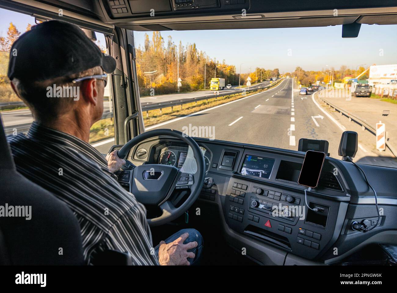 View from inside the cab of the truck. Car transport. The truck is ...