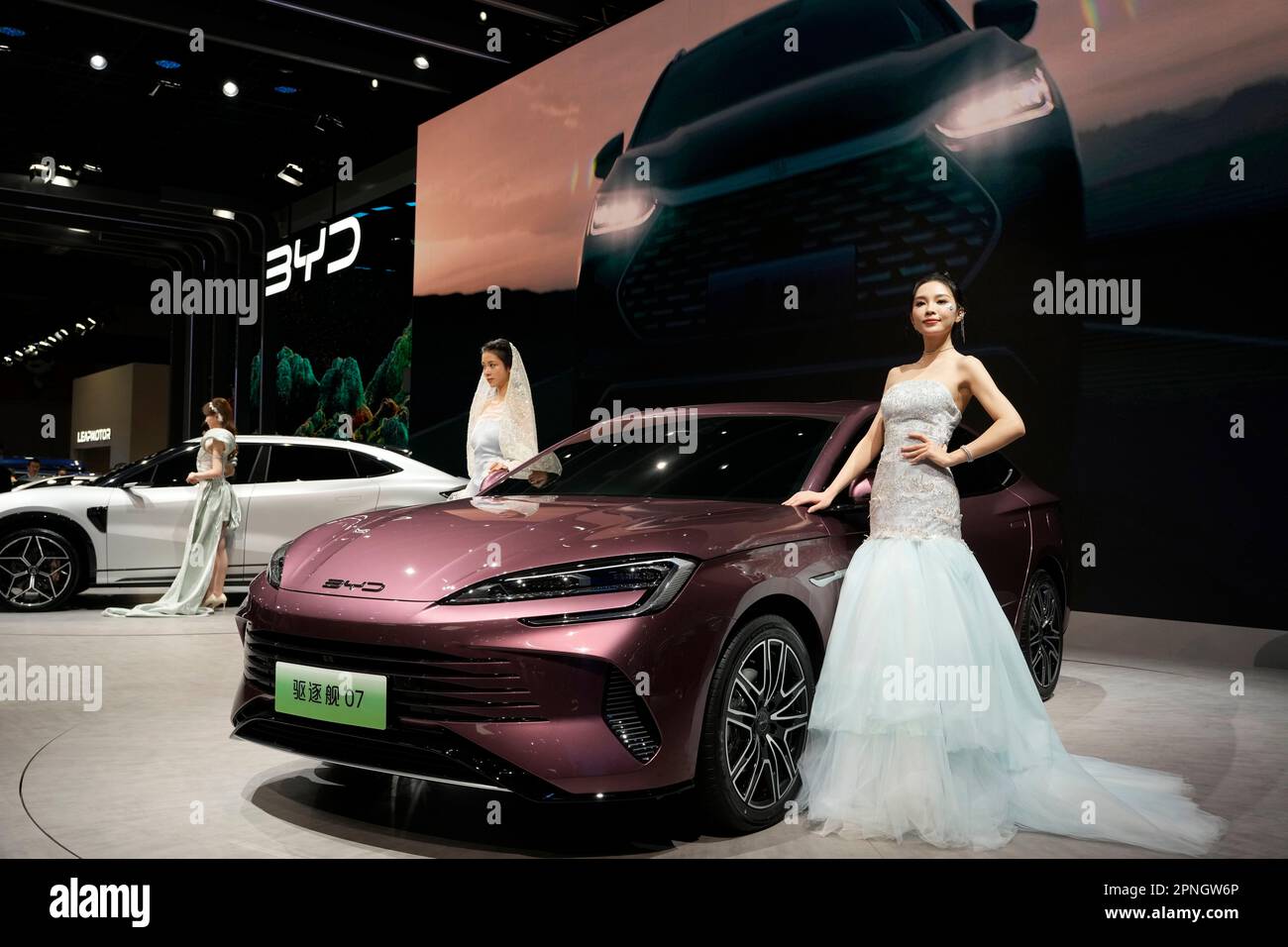 Models pose near the latest offering from Chinese automaker BYD during ...