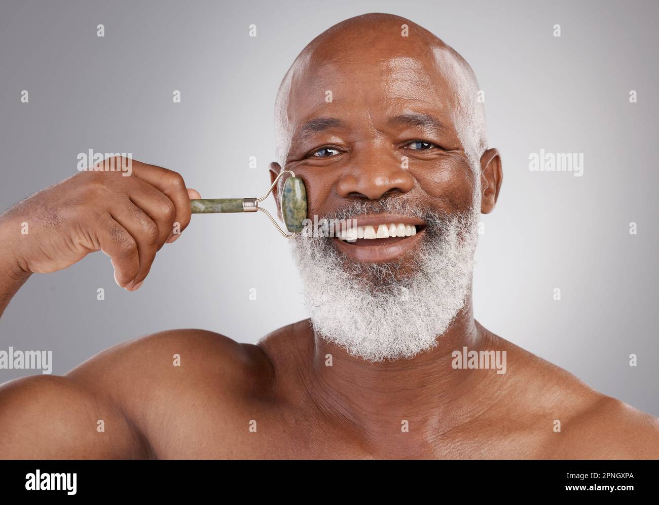 Face roller, portrait and smile for senior black man with skincare ...