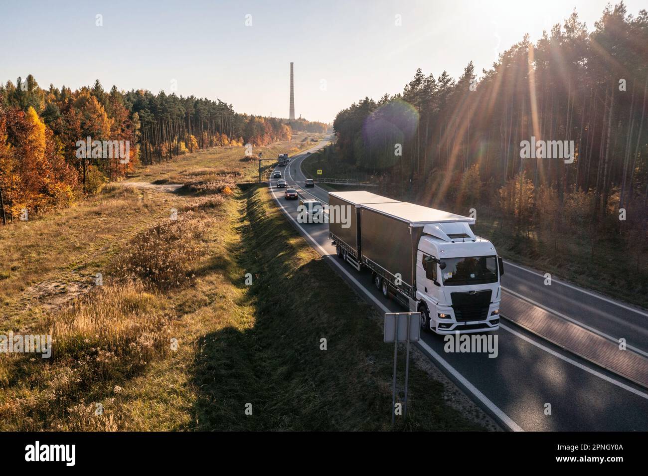 Truck is driving through the forest in autumn. Truck with semi-trailer ...