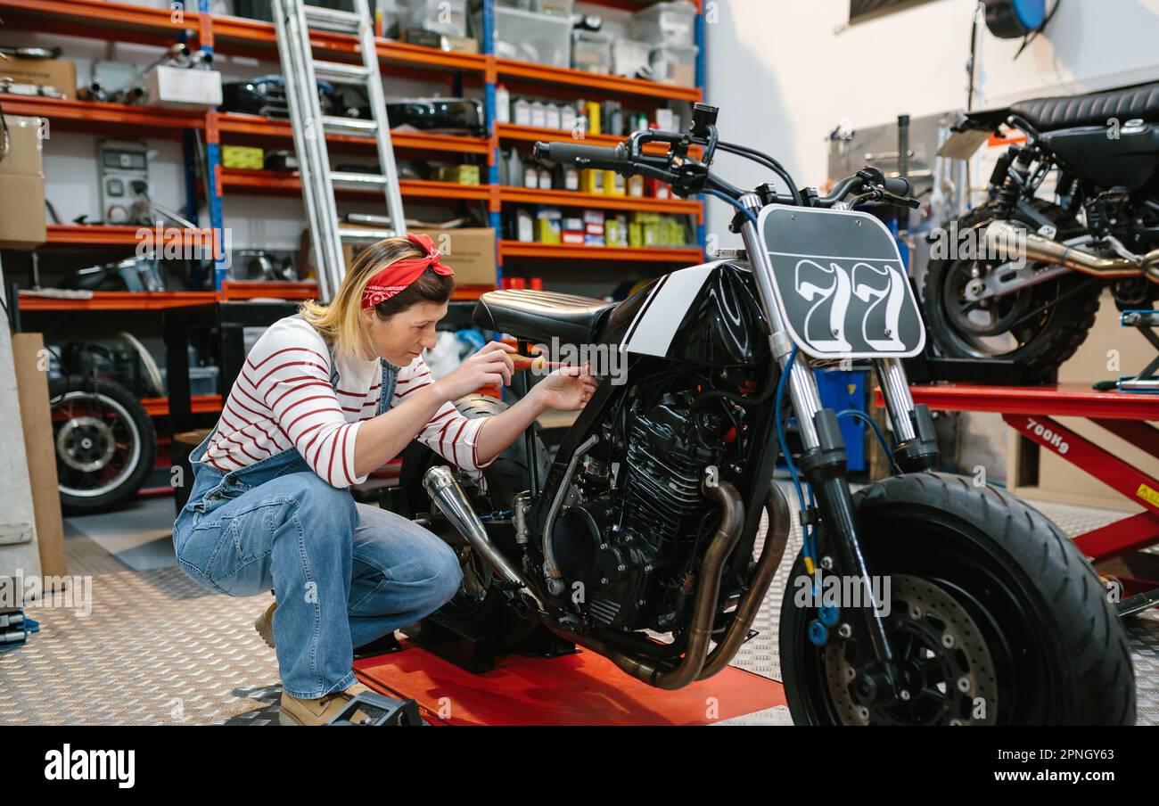Female biker repairing motorbike engine hi-res stock photography and ...