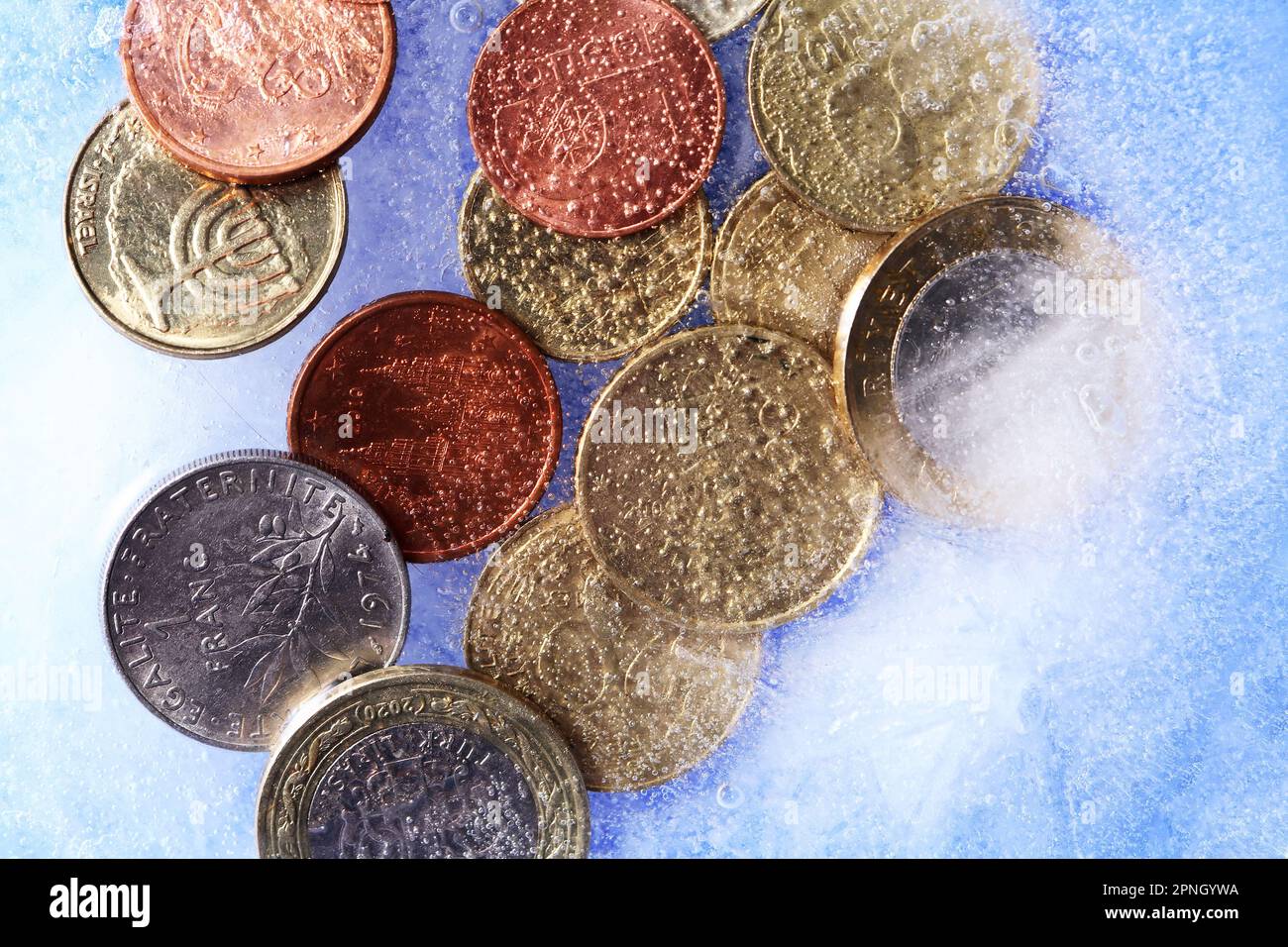 Frozen deposit. Set of various coins frozen into ice surface Stock ...