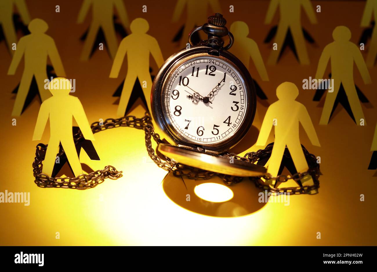Lot of men figures cutting from yellow paper around pocket watch Stock ...