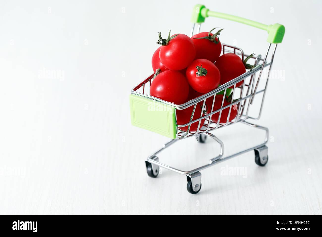 Healthy eating concept. Shopping cart with red freshness tomatoes Stock ...