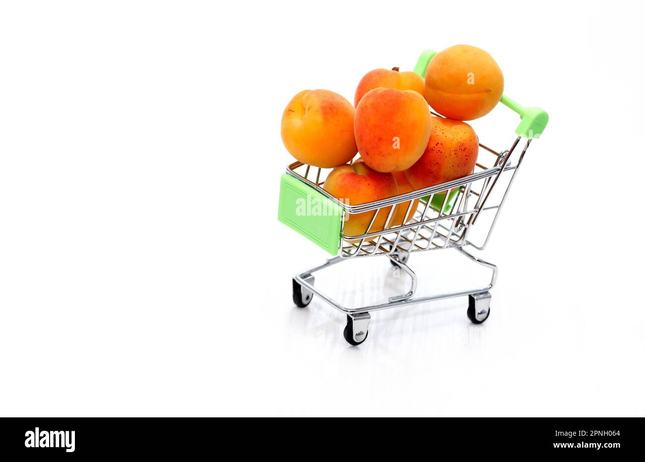Healthy eating concept. Shopping cart with freshness apricots Stock ...