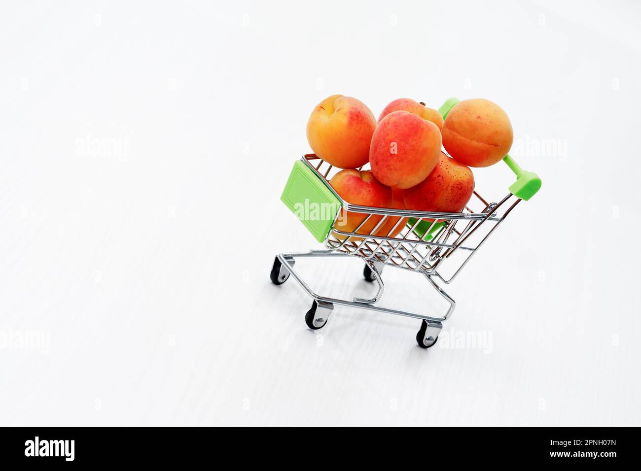 Healthy eating concept. Shopping cart with freshness apricots Stock ...