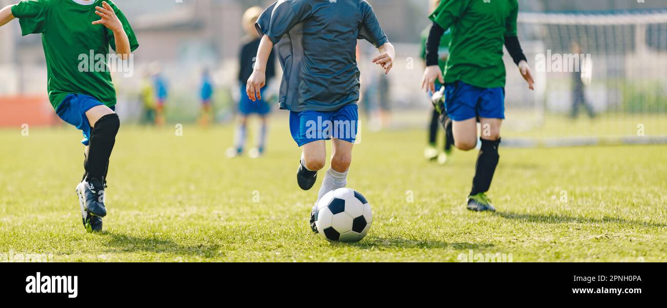 Happy Schooll Boys Kicking Soccer Ball. Group of Young Soccer Players ...
