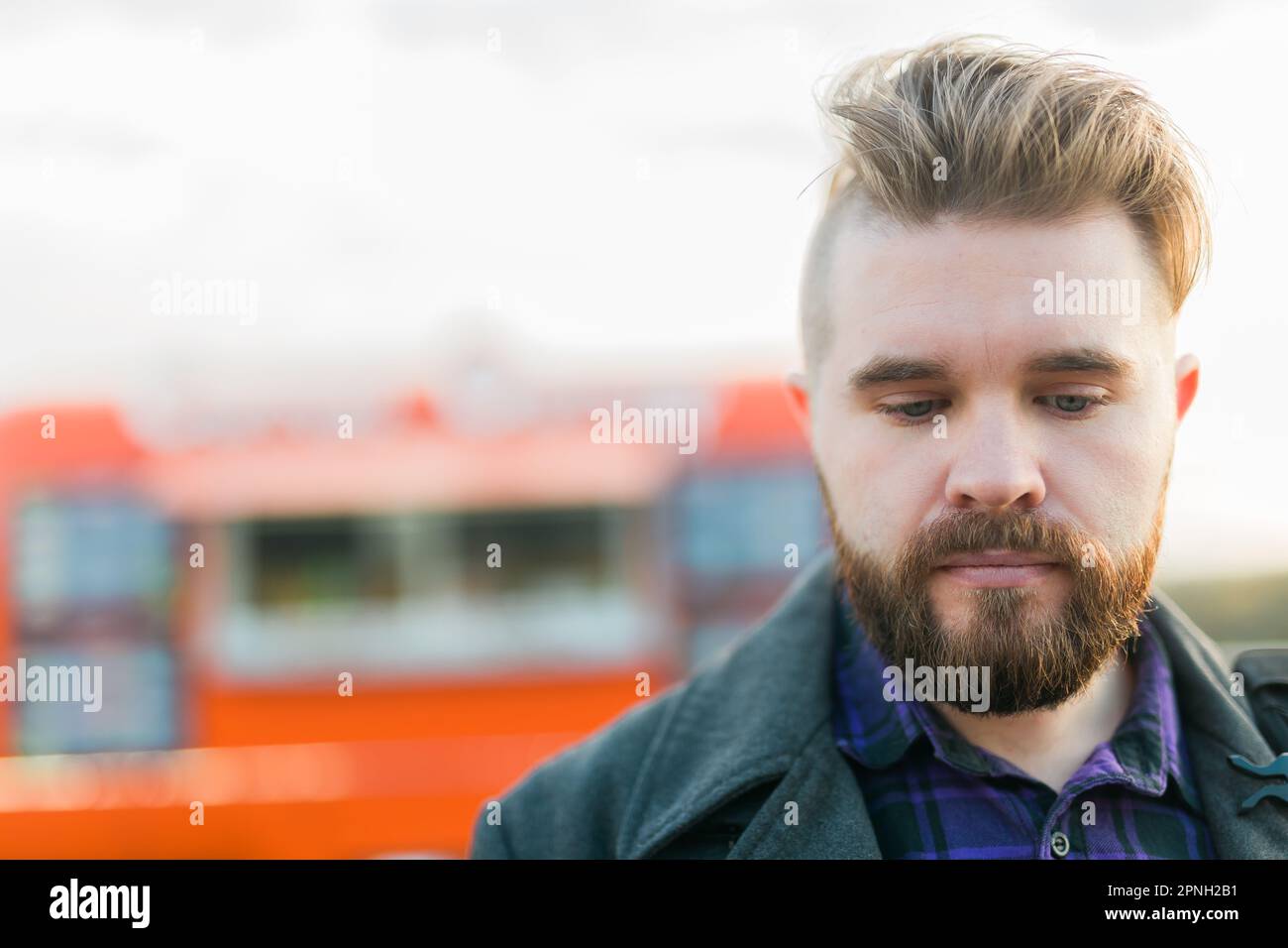 Portrait of bearded man suffering for depression outdoor on background ...
