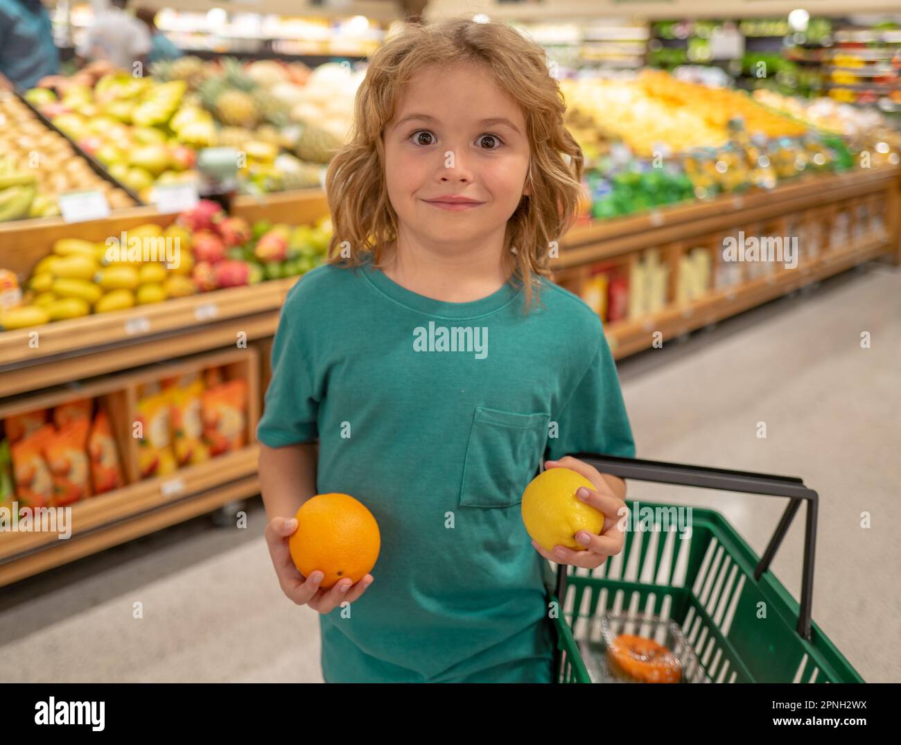 Healthy food for kids. Child with lemon and orange. Portrait of smiling ...