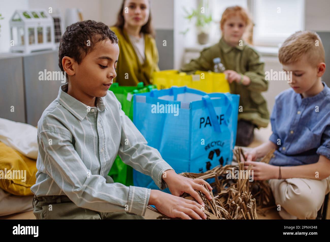 Children separating rubish in to three bins Stock Photo - Alamy