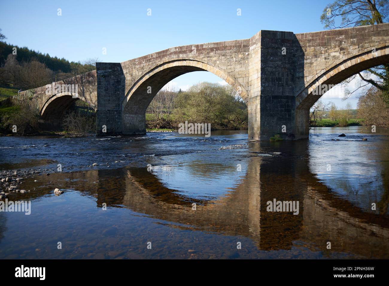 Barden Bridge, a three arch stone bridge over the river Wharfe in North ...