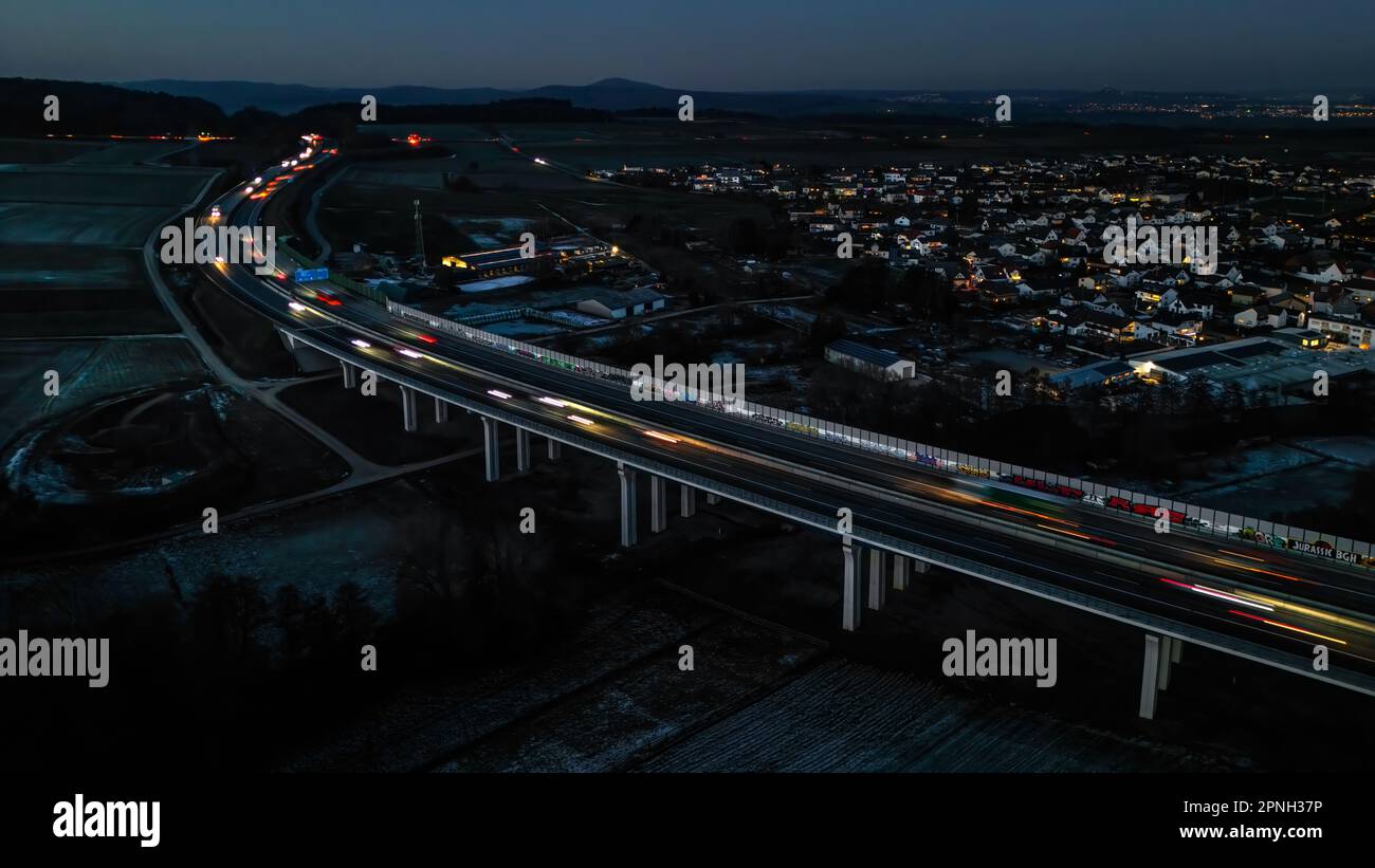 high angle view of motorway bridge going through the country at night ...