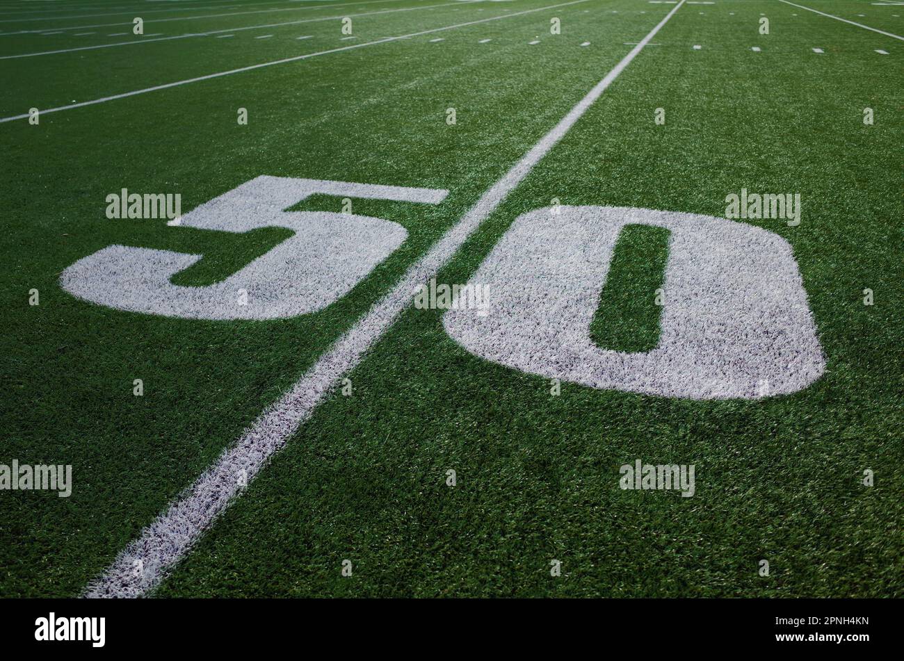 A green football field with painted number 50 Stock Photo - Alamy