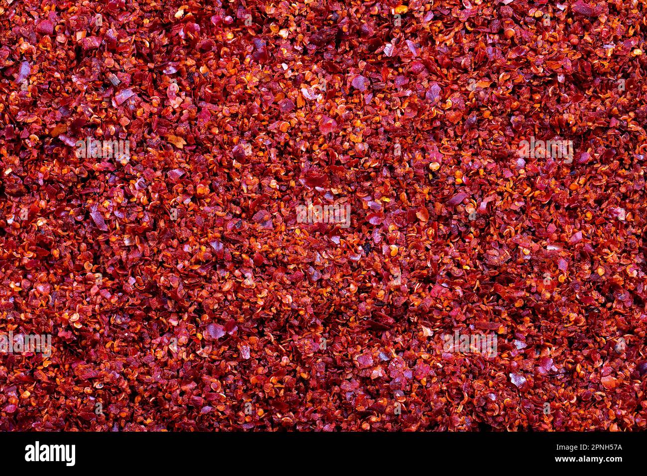 Red chili flakes. Crushed chili pepper or dried chili flakes background ...