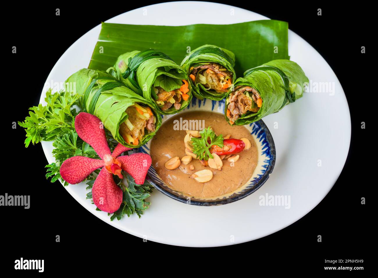 Vietnamese nem spring rolls in leaf with sauce Stock Photo - Alamy