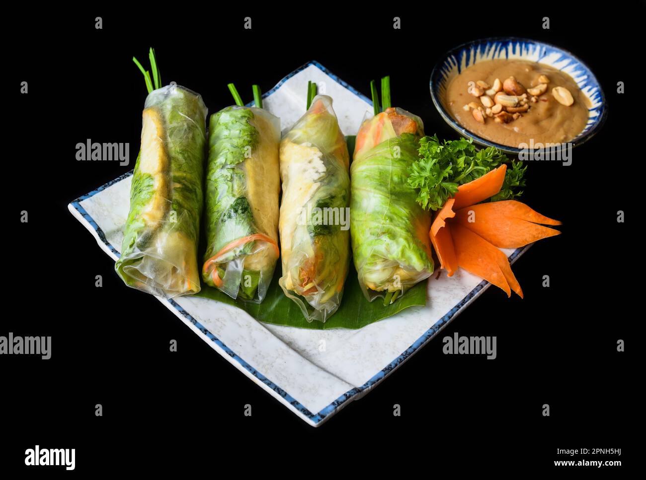 Vietnamese nem spring rolls in leaf with sauce Stock Photo - Alamy
