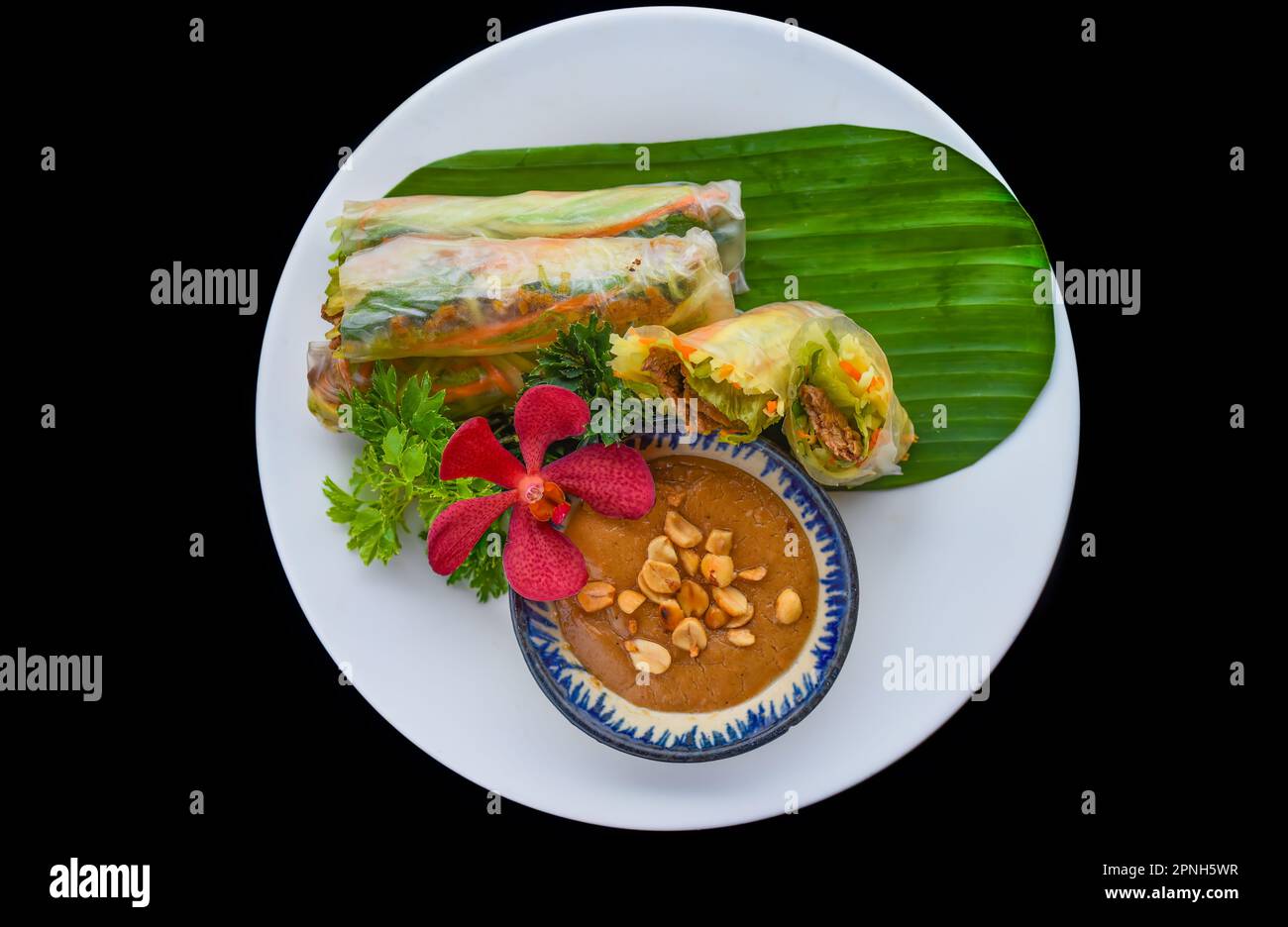 Vietnamese nem spring rolls in leaf with sauce Stock Photo - Alamy