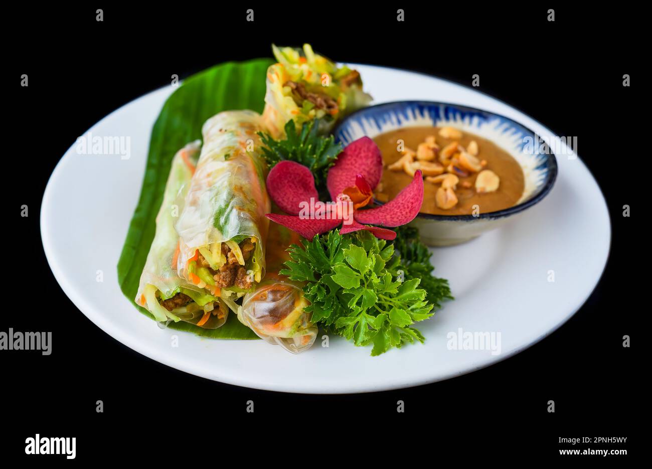 Vietnamese nem spring rolls in leaf with sauce Stock Photo - Alamy
