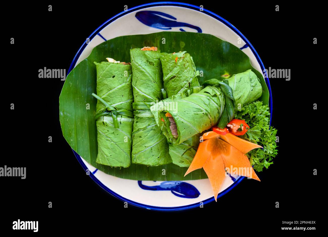 Vietnamese nem spring rolls in leaf with sauce Stock Photo - Alamy