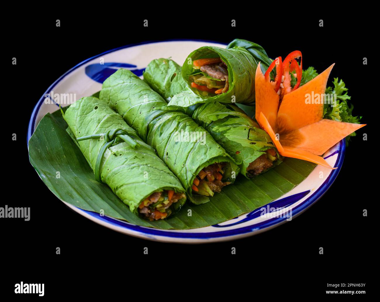Vietnamese nem spring rolls in leaf with sauce Stock Photo - Alamy