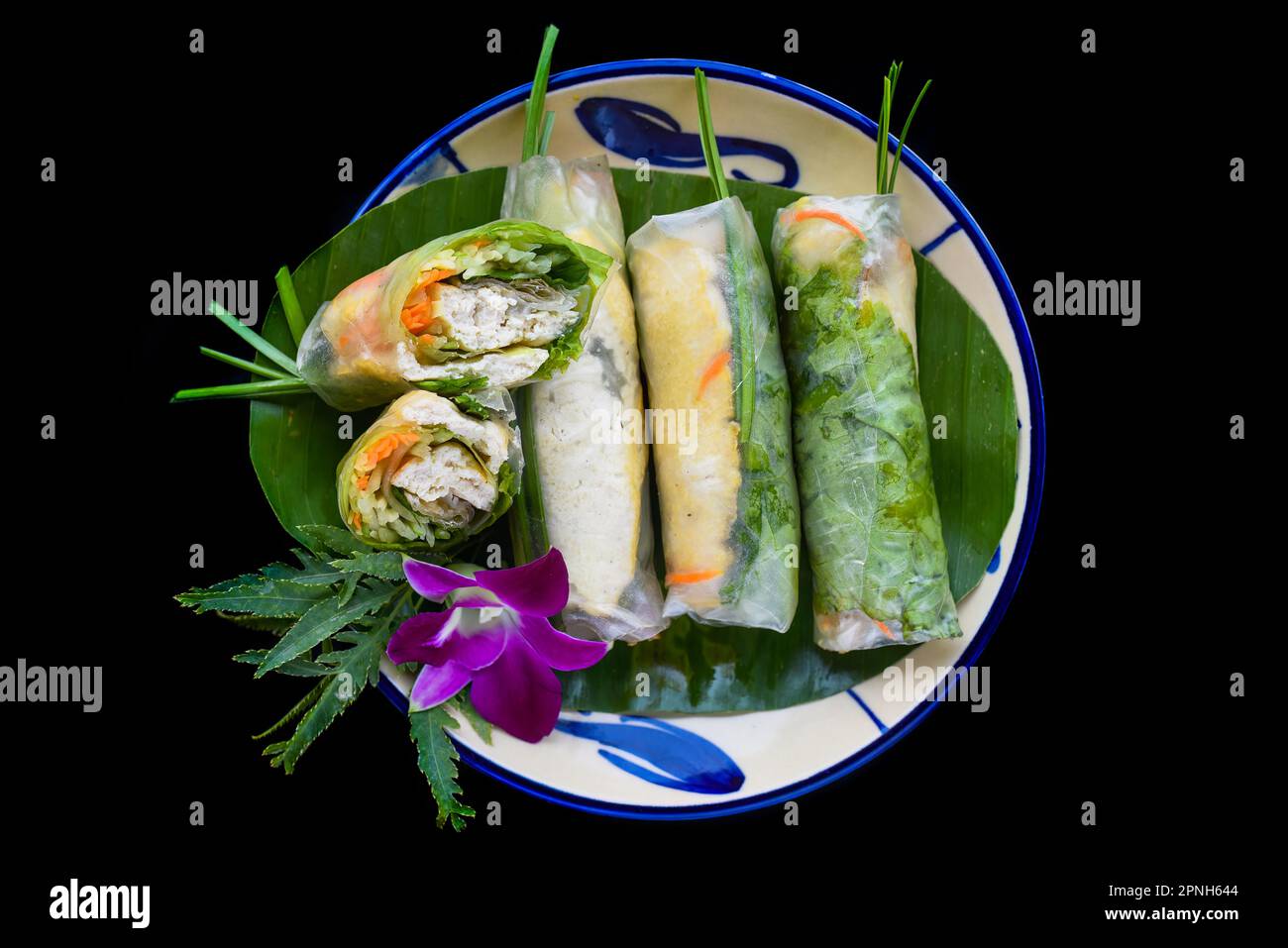 Vietnamese nem spring rolls in leaf with sauce Stock Photo - Alamy