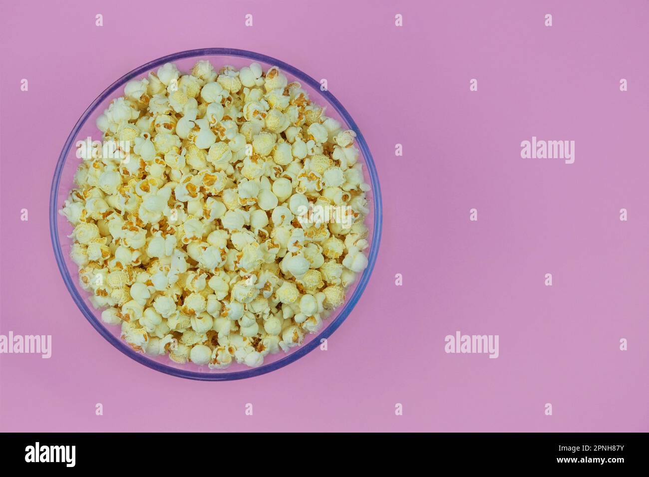 Popcorn large bowl on a pink background. Fast food for cinema. Top view ...