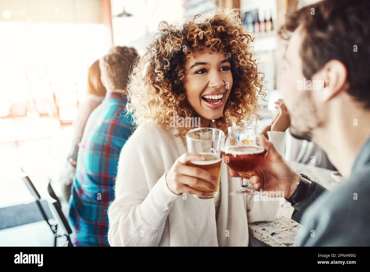 Cheers to always laughing. a young couple enjoying a drink at a bar ...