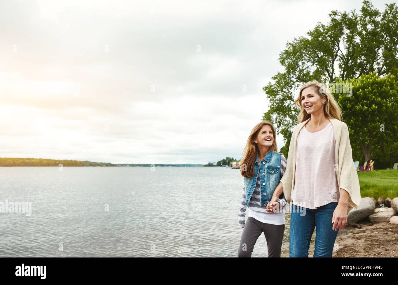Make the time to strengthen valuable bonds. a mother and her daughter bonding outdoors Stock ...