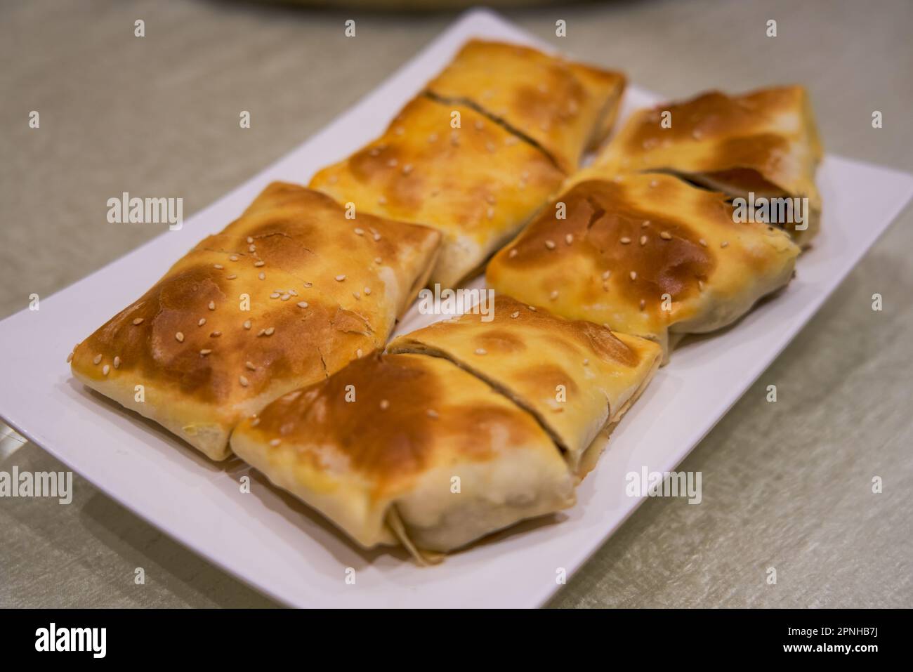 A delicious Chinese Xinjiang dish, baked buns Stock Photo - Alamy