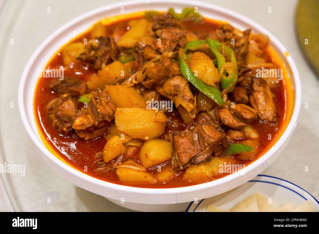 A delicious Chinese Xinjiang dish, big plate chicken Stock Photo - Alamy