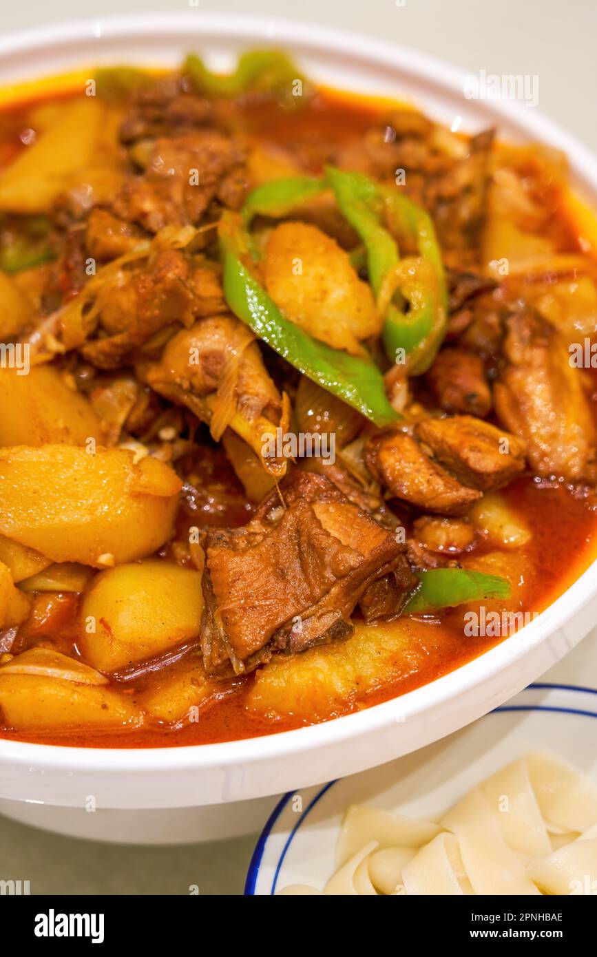 A delicious Chinese Xinjiang dish, big plate chicken Stock Photo - Alamy