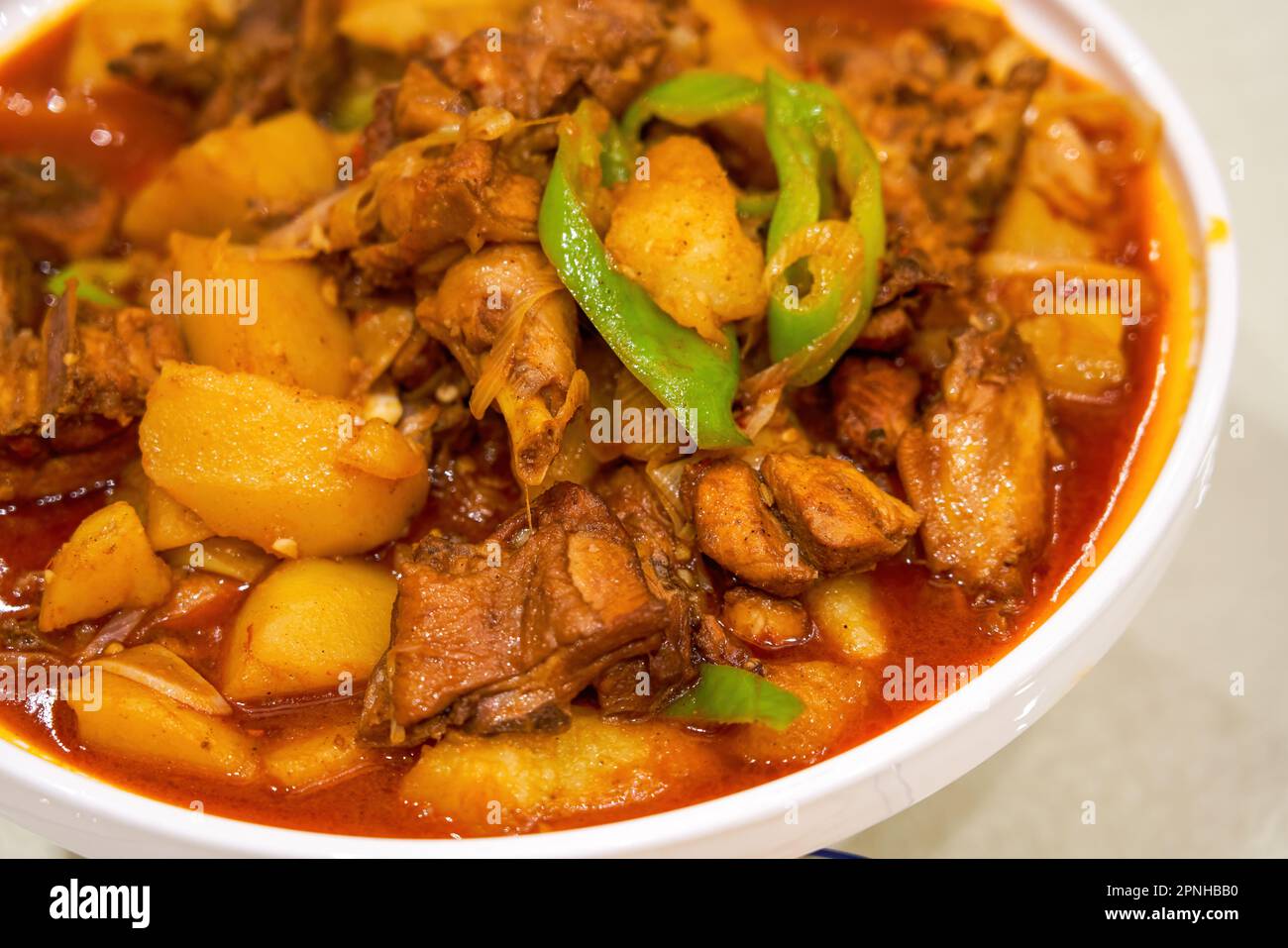 A delicious Chinese Xinjiang dish, big plate chicken Stock Photo - Alamy